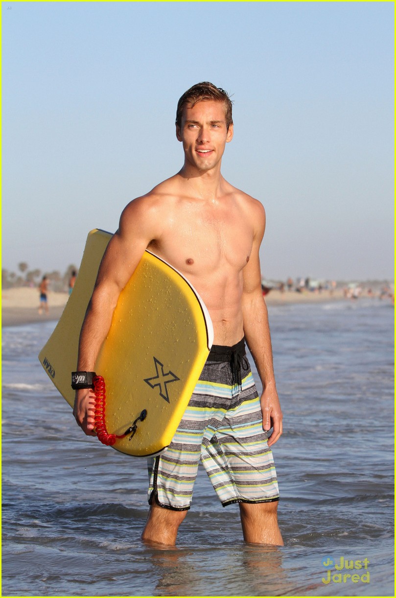 Shirtless Austin North Gets Wiped Out by Waves While Boogie Boarding ...